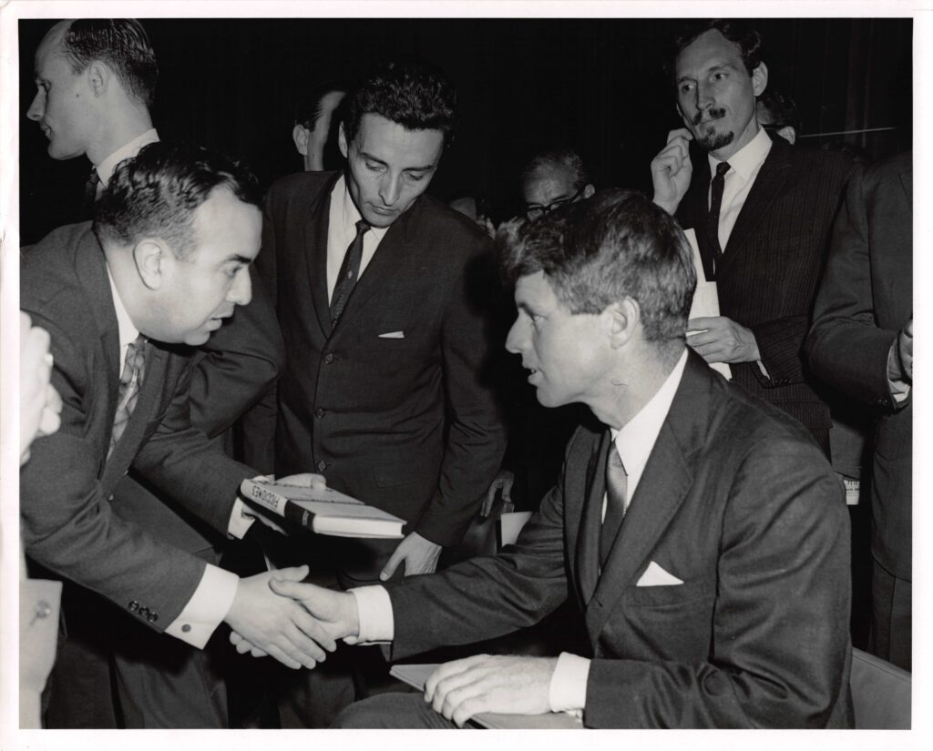 RFK signs autographs during a visit to Argentina - Robert F. Kennedy ...